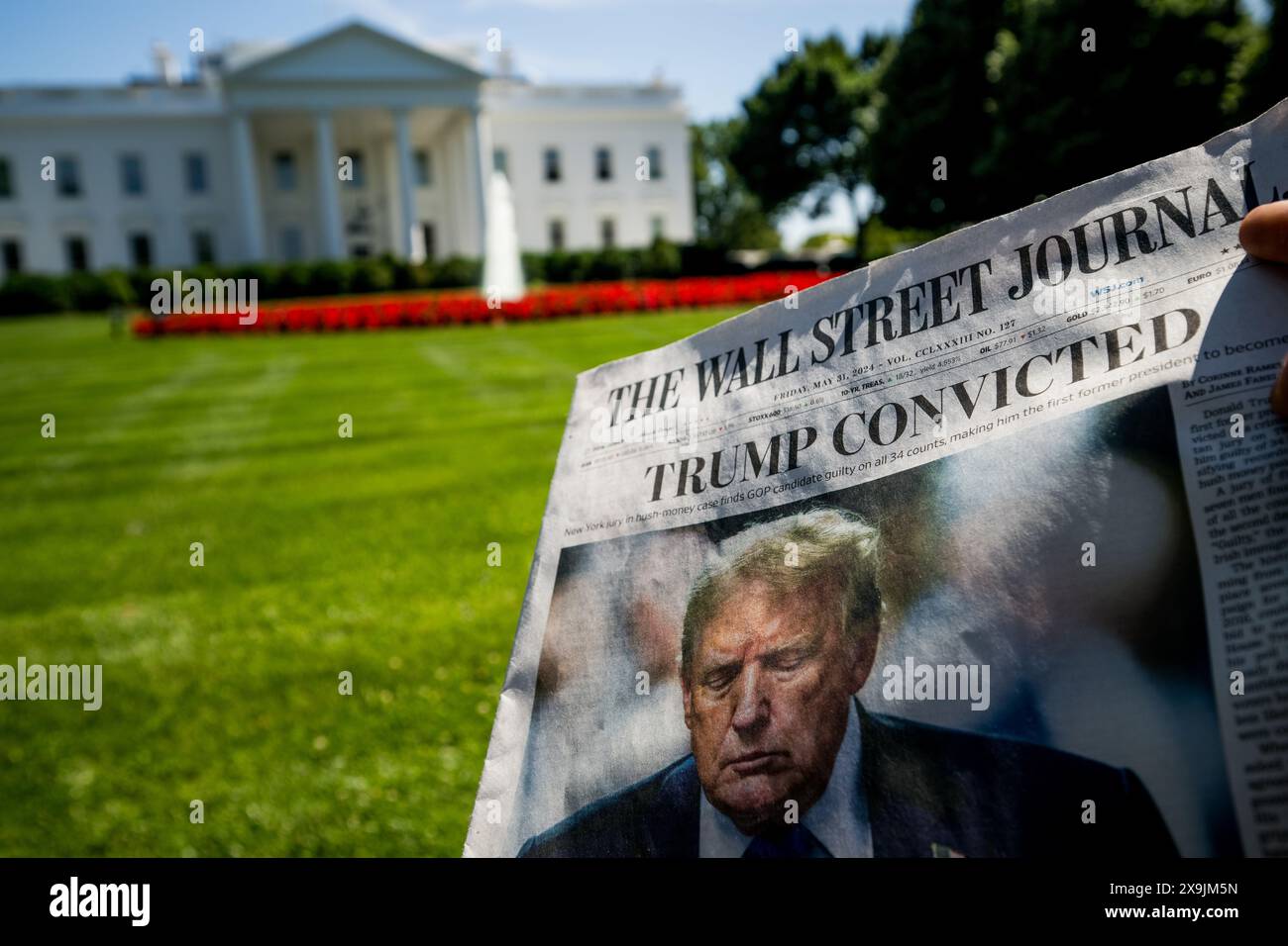 A journalist shows a 'The Wall Street Journal' newspaper with the ...