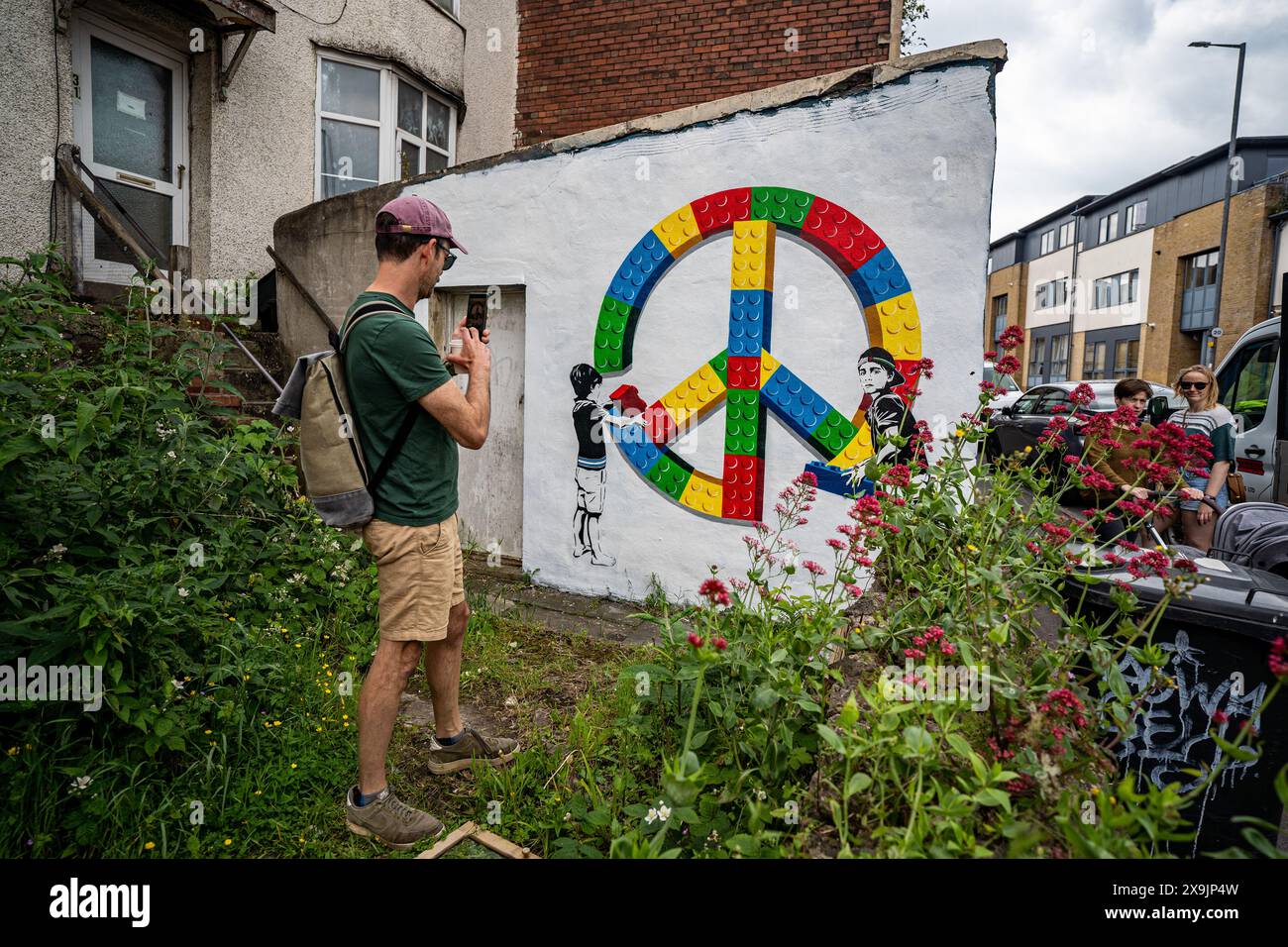 People photograph a new graffiti artwork at the Upfest Presents ...