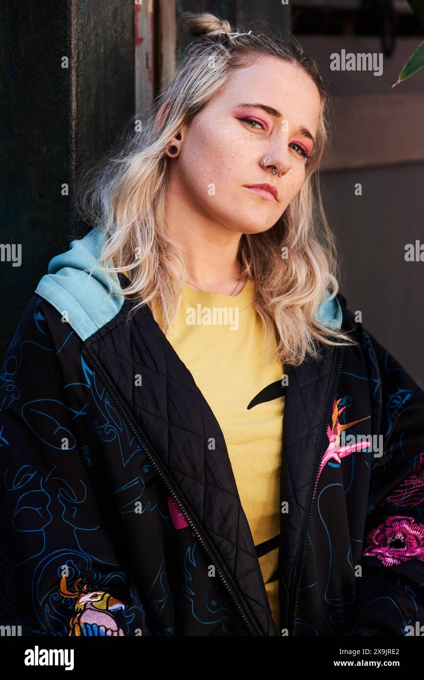 Outdoor portrait, woman and serious for fashion with makeup for edgy ...