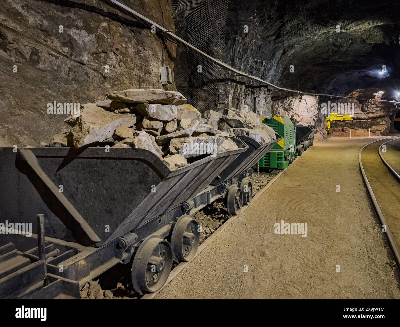 Mining cart filled with rocks in a old abandoned mine tunnel Stock ...
