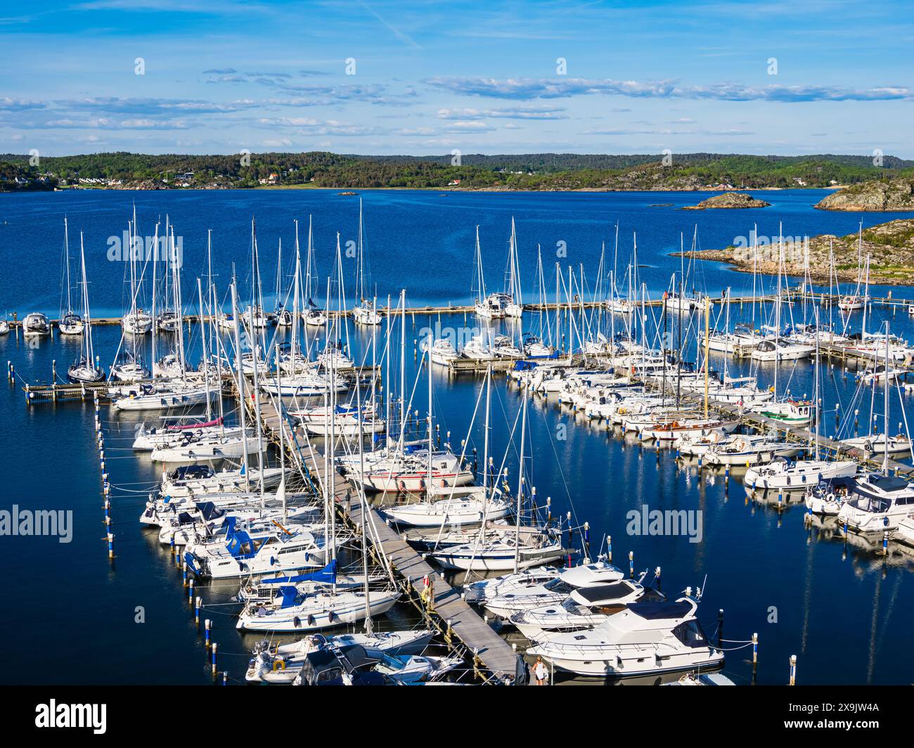 An aerial view of a harbor in Sweden on a bright, sunny day. Numerous ...