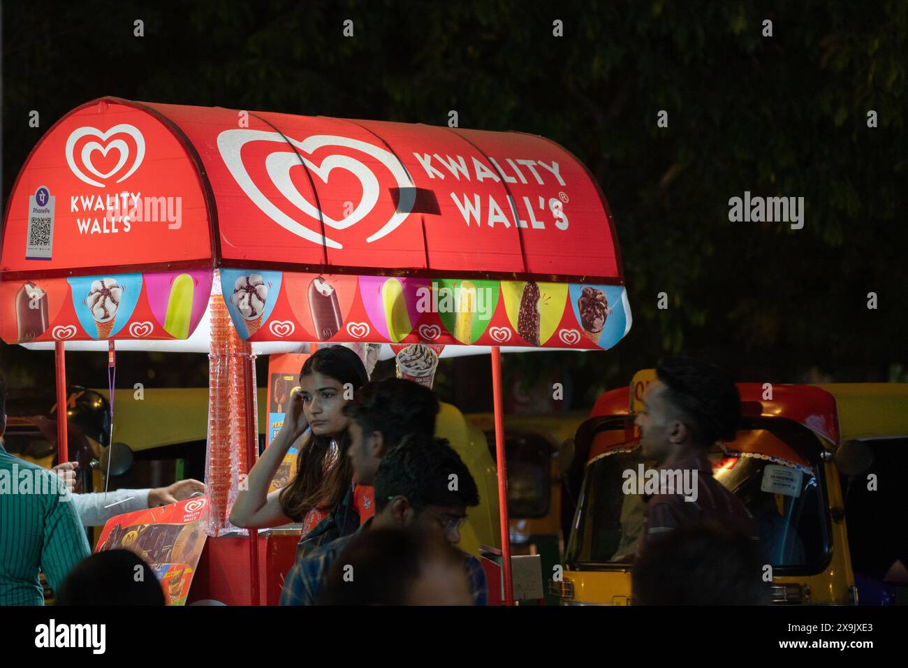 Kwality Wassl Ice cream wagon truck cart at night with people surrounding it showing the heat ...