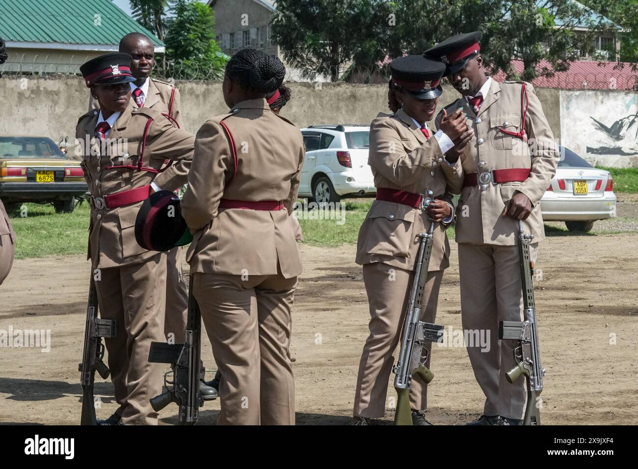 Kenyan police officers wearing ceremonial uniform interact during the ...