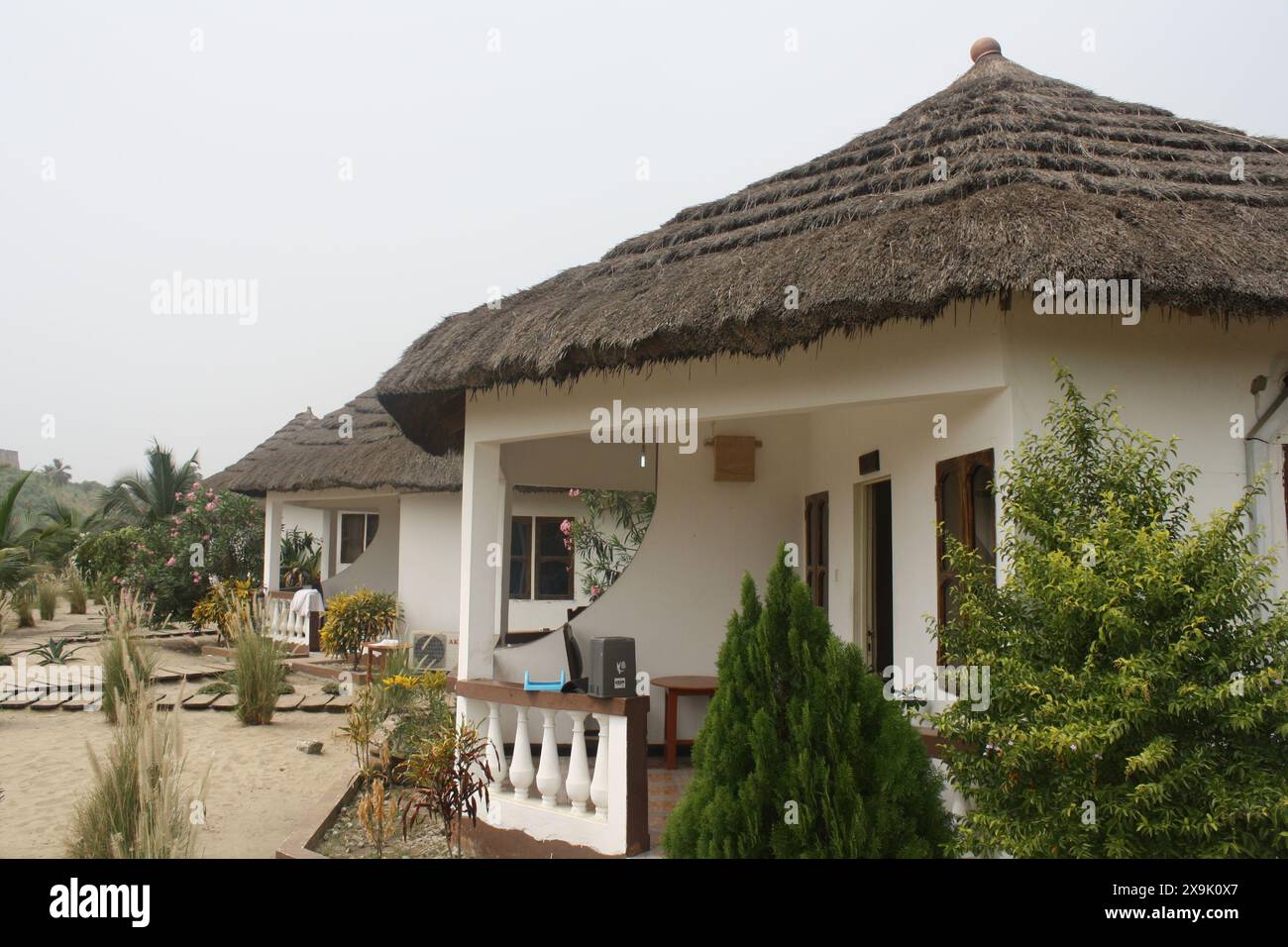 A picturesque view of traditional thatched roof huts surrounded by lush ...