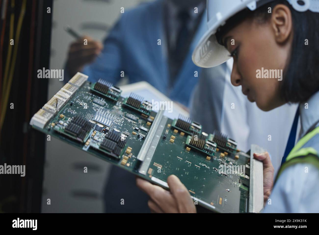 Woman, motherboard and server room for internet infrastructure or ...