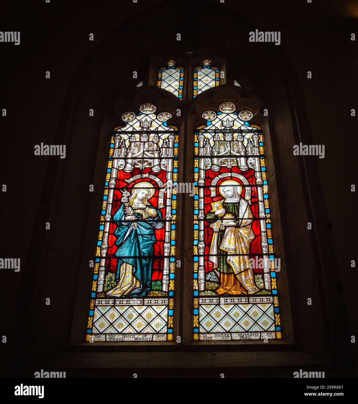 Colorful stained glass window depicting religious figures in a gothic ...