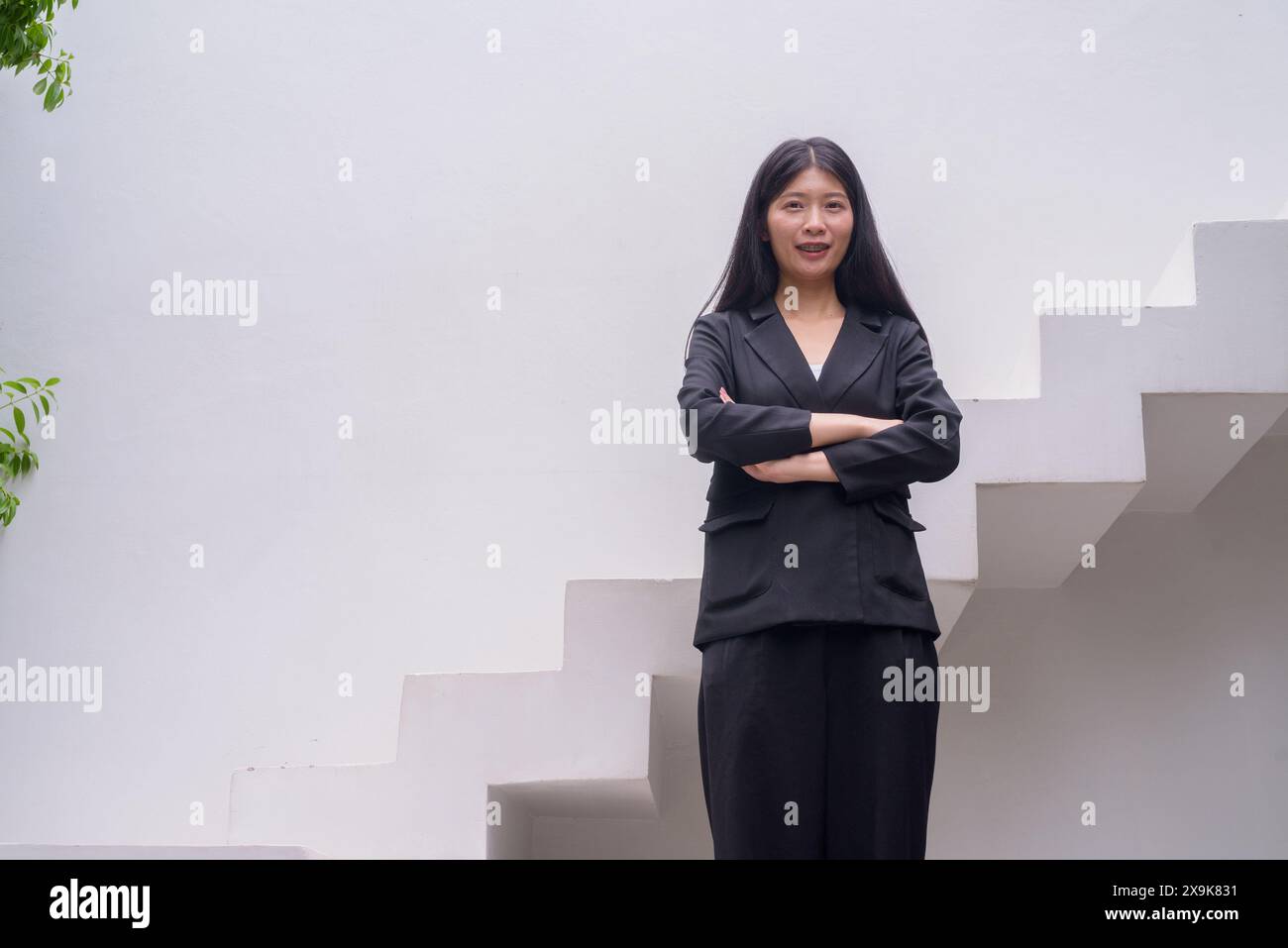 Portrait of a professional woman in business attire exuding confidence on modern architectural ...