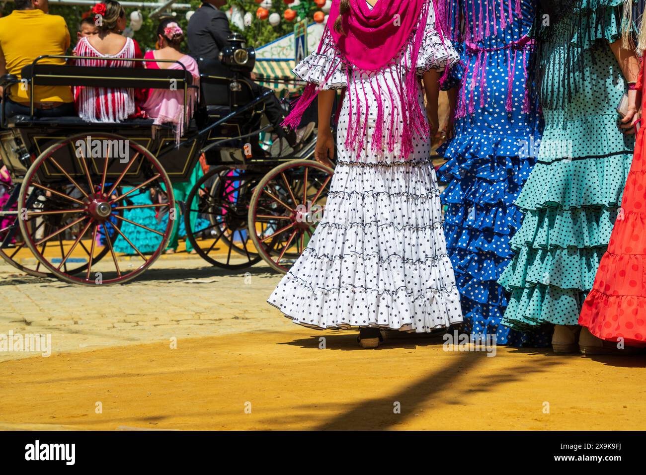 Stylish women in traditional Spanish flamenco dresses, enjoy the ...