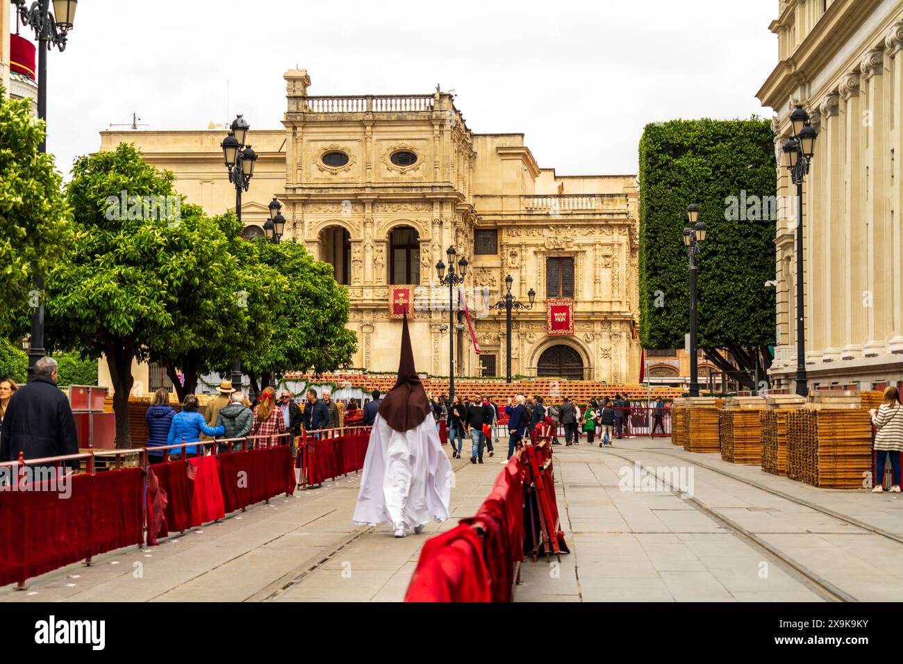 Seville Holy Week (Semana Santa), a man in traditional white religious ...