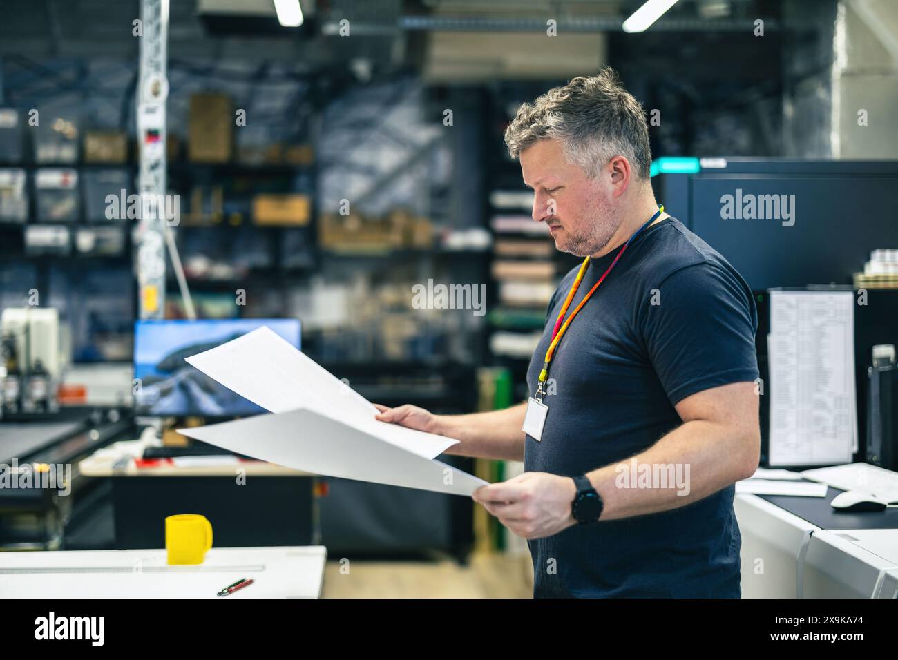 Man working in a printing factory Stock Photo - Alamy