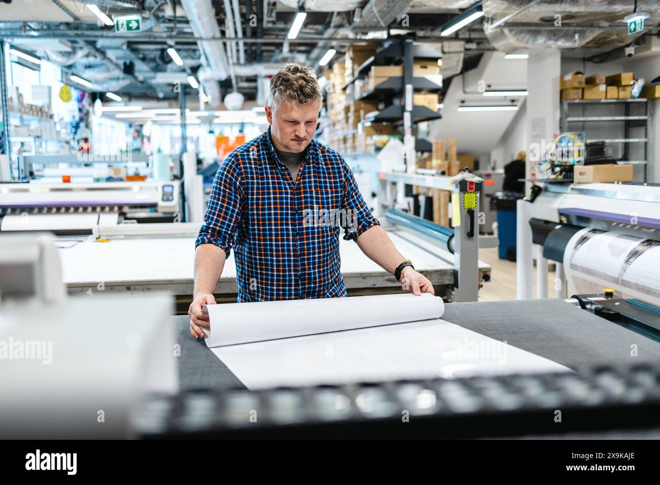 Man working in a printing factory Stock Photo - Alamy