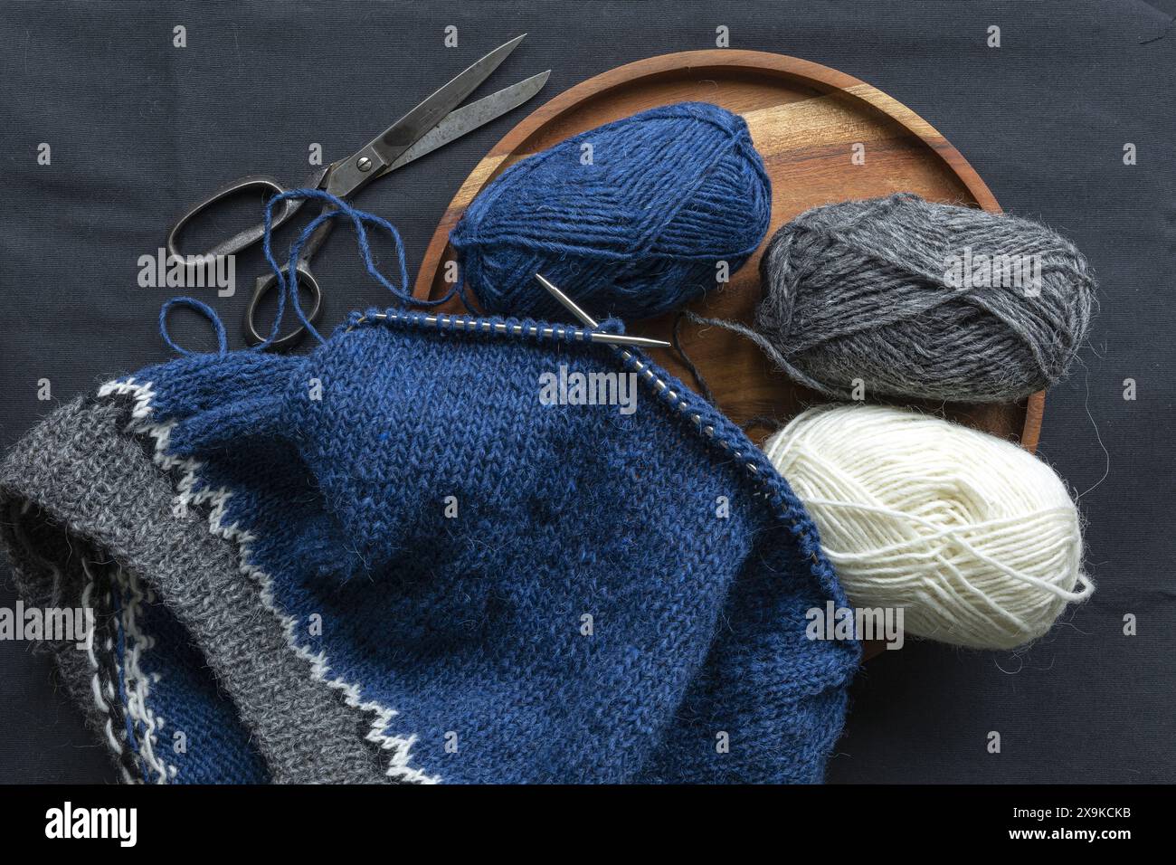 Flat lay photography of a blue grey white wool knitted sweater on the ...