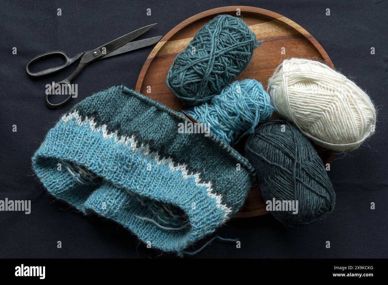 Flat lay photography of a turquoise green white wool knitted sweater on ...