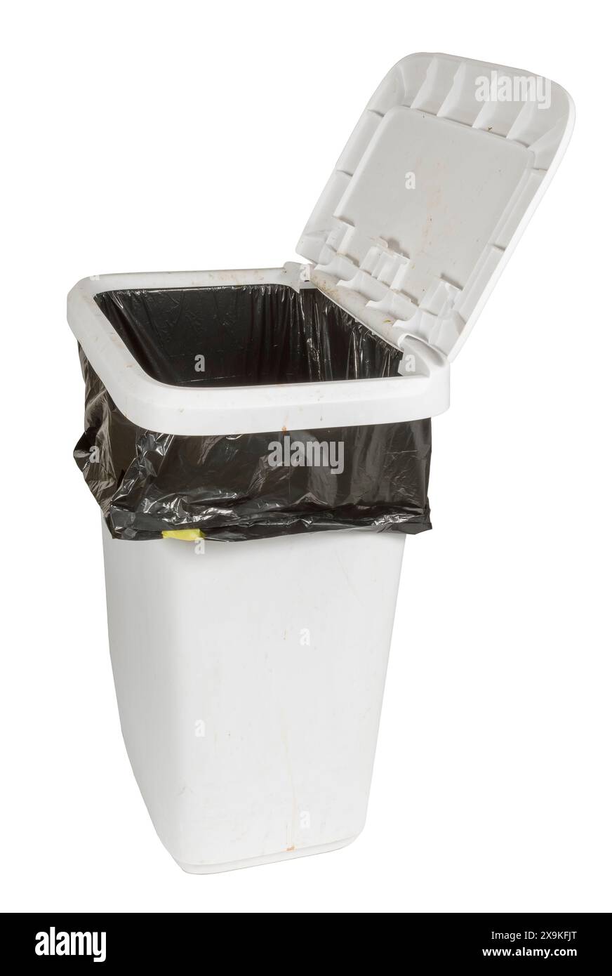 Vertical side shot of a dirty white tall kitchen trash can with black ...