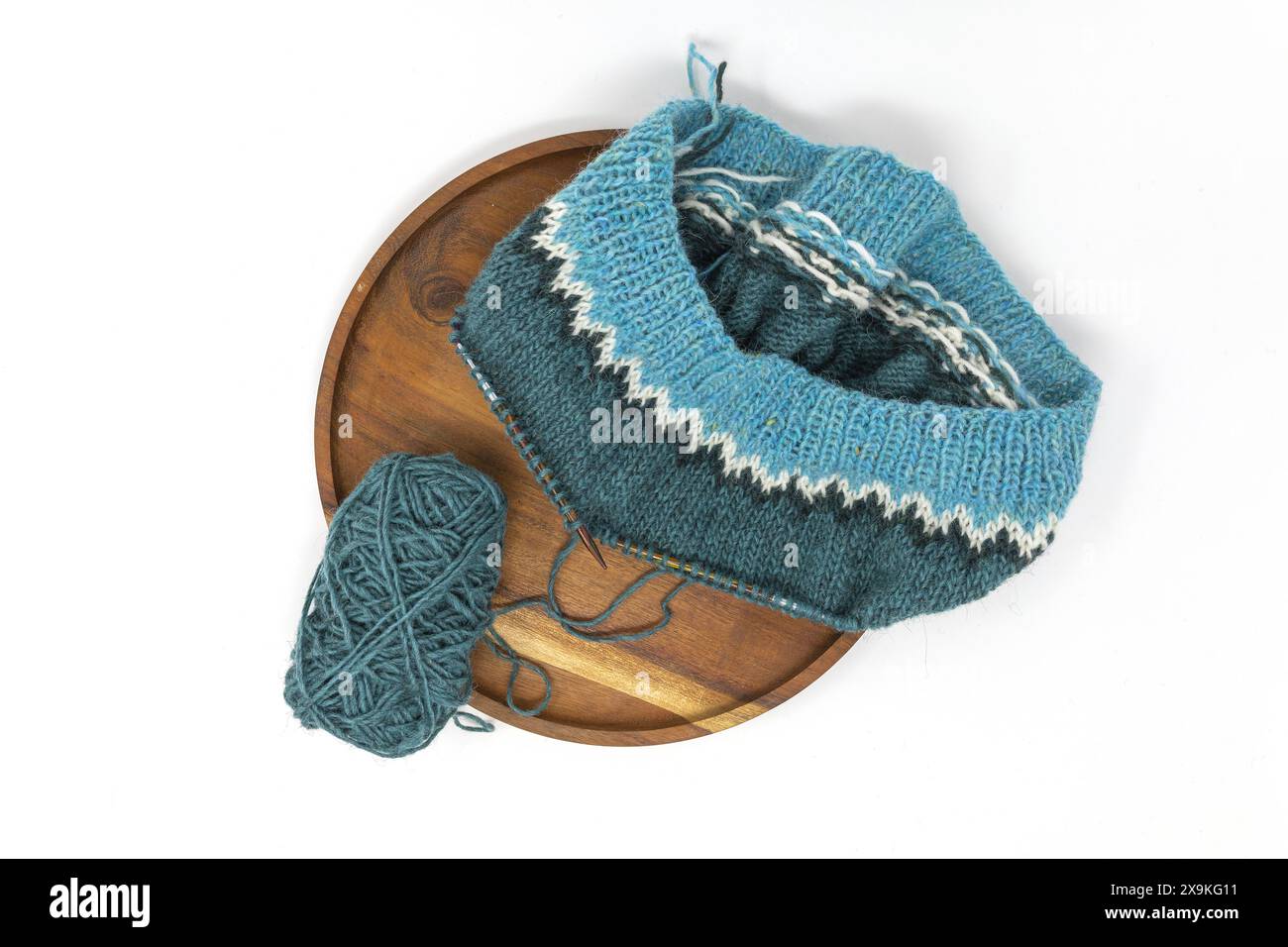 flat lay photography of a teal turquoise white wool yarn knitting on a ...