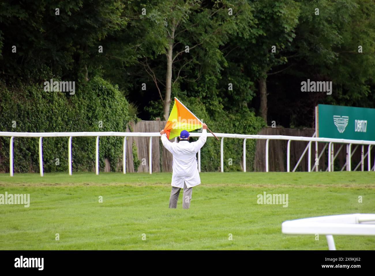 Epsom Downs Surrey, UK. 1st June, 2024. Course marshall holds the ...