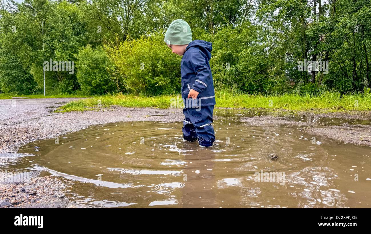 Boy running through puddles hi-res stock photography and images - Alamy