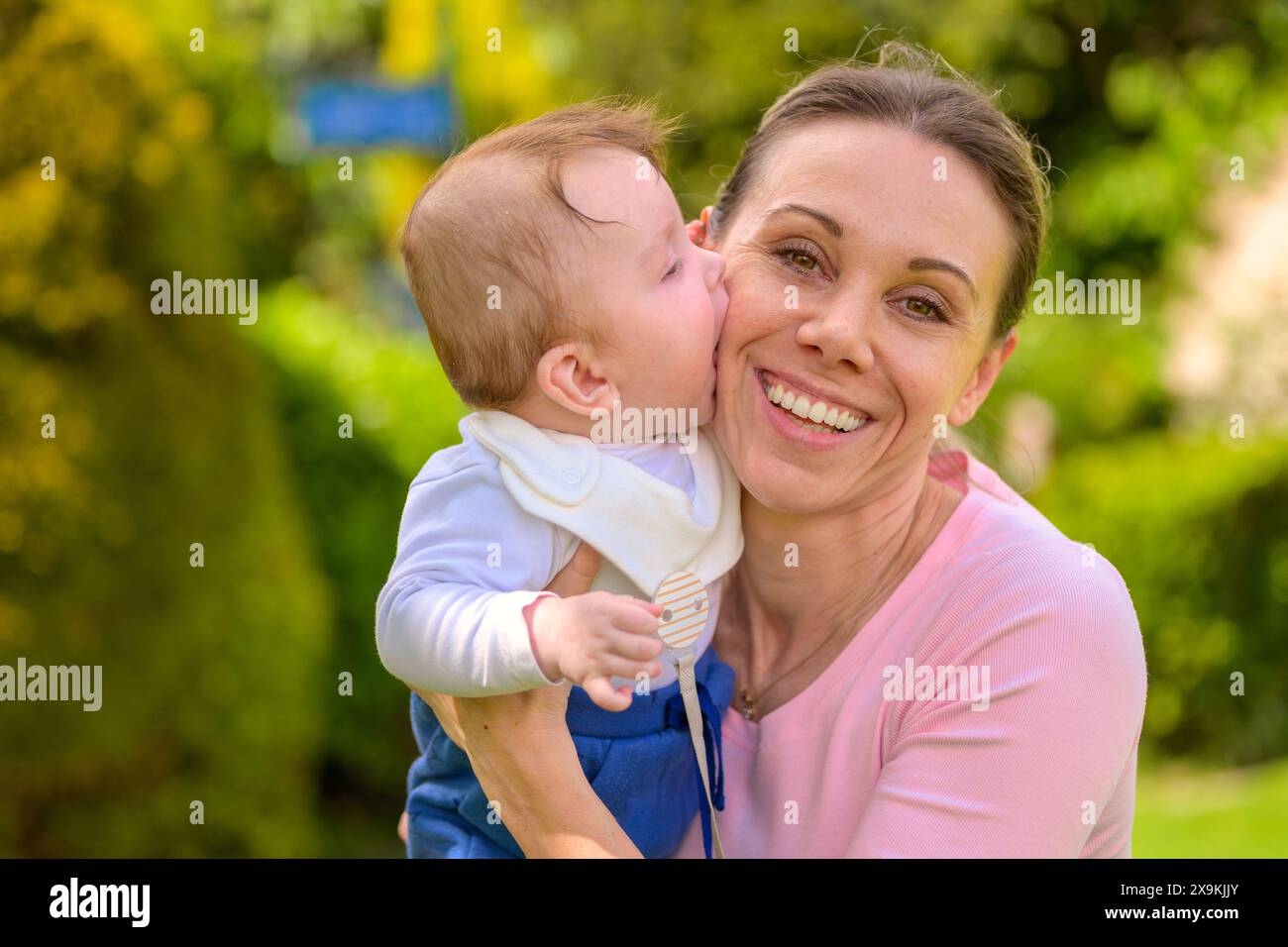 A heartwarming scene of a mother holding her baby close as the baby ...