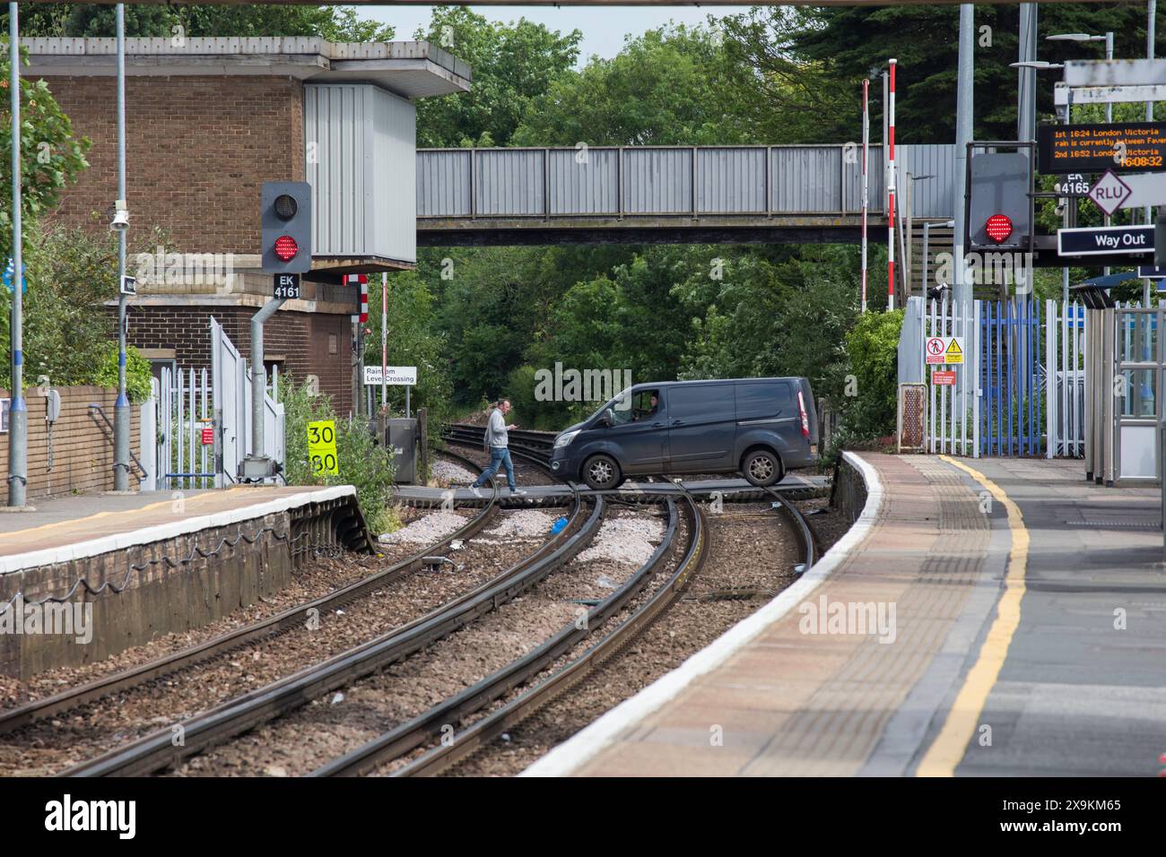 Railway level crossing Rainham Kent with a van and a man crossing the tracks Stock Photo - Alamy