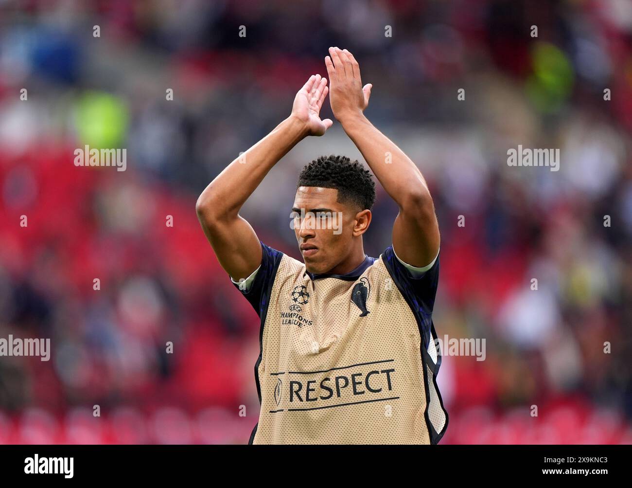 Real Madrid's Jude Bellingham applauds the fans as he warms up ahead of ...