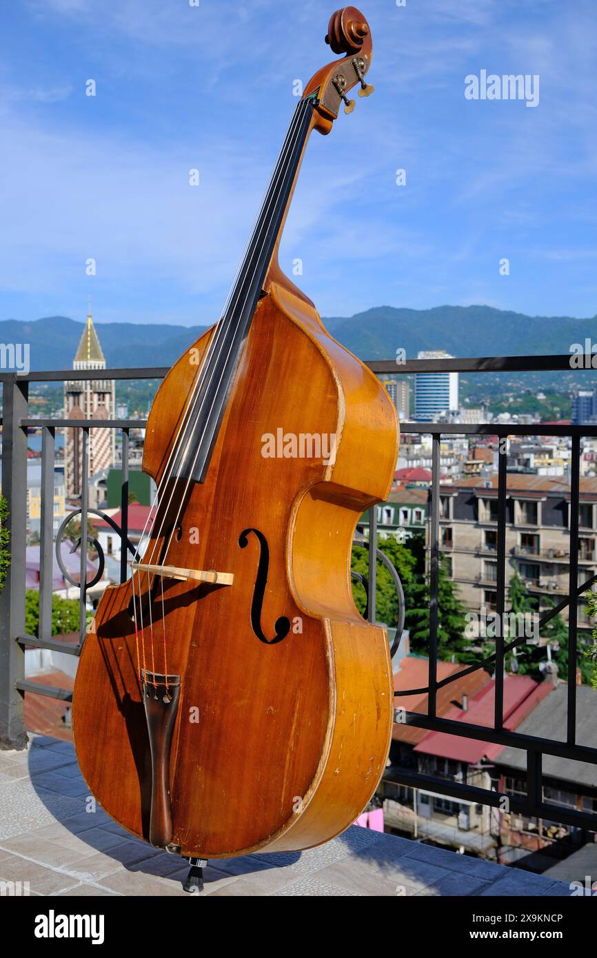 hand-carved double bass against a city background Stock Photo - Alamy