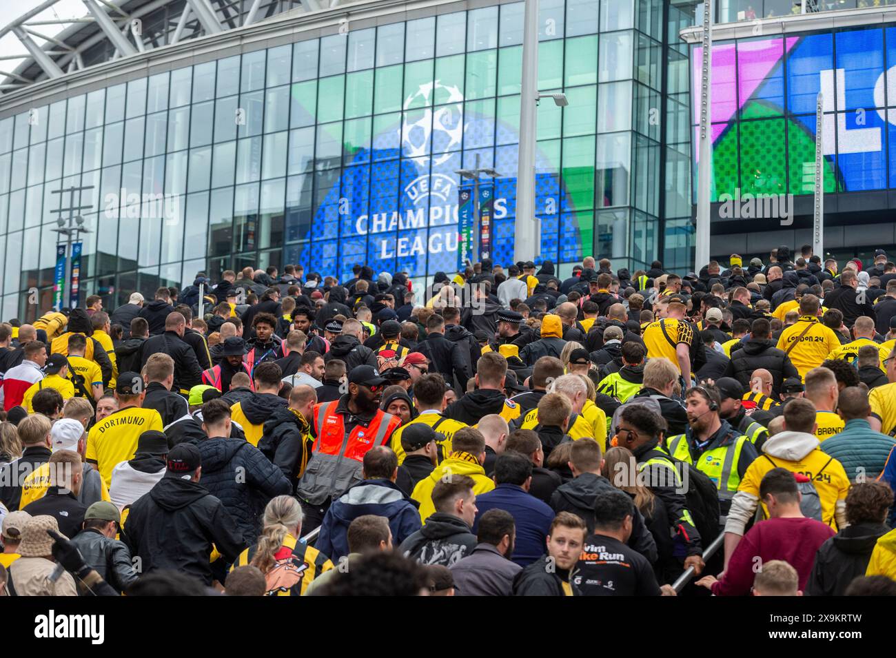 London, UK. 1 June 2024. Dortmund fans rush through ticket checks ahead ...