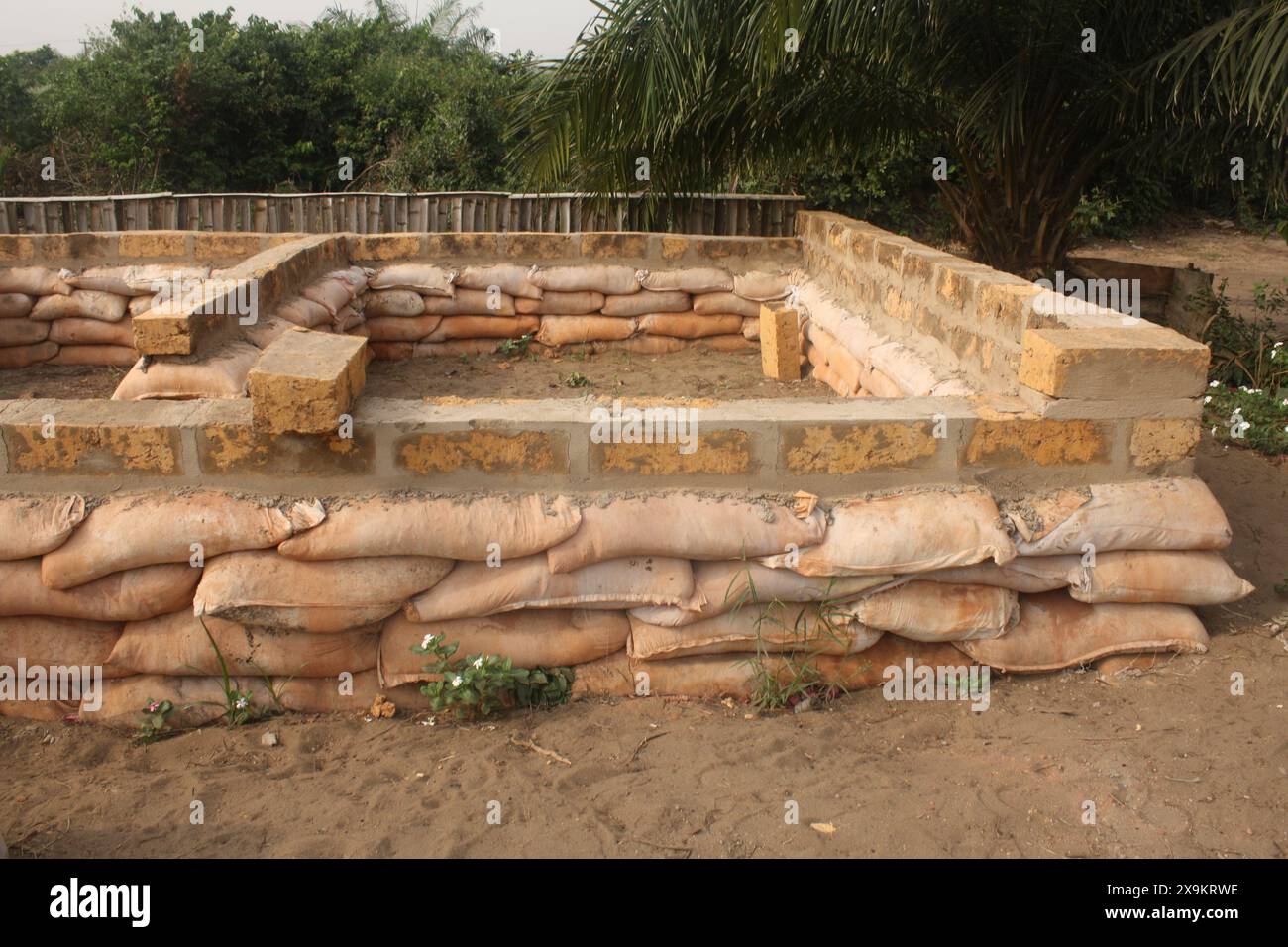 The foundation of a structure made with sandbags and bricks, showcasing ...