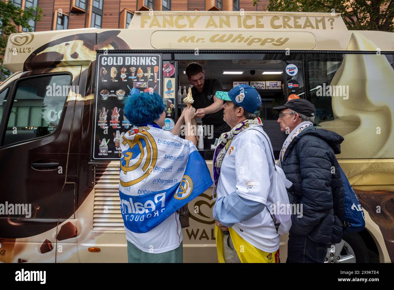 London, UK. 1 June 2024. Real Madrid fans by ice cream in Olympic Way ...