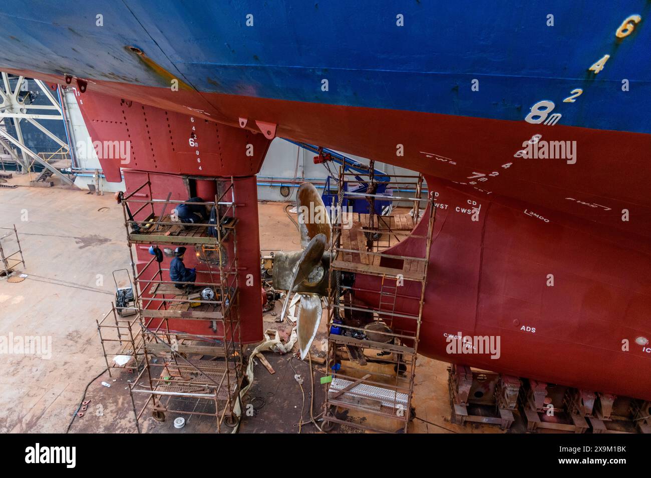 Cargo vessel in dry dock on ship repairing yard. Variable pitch ...