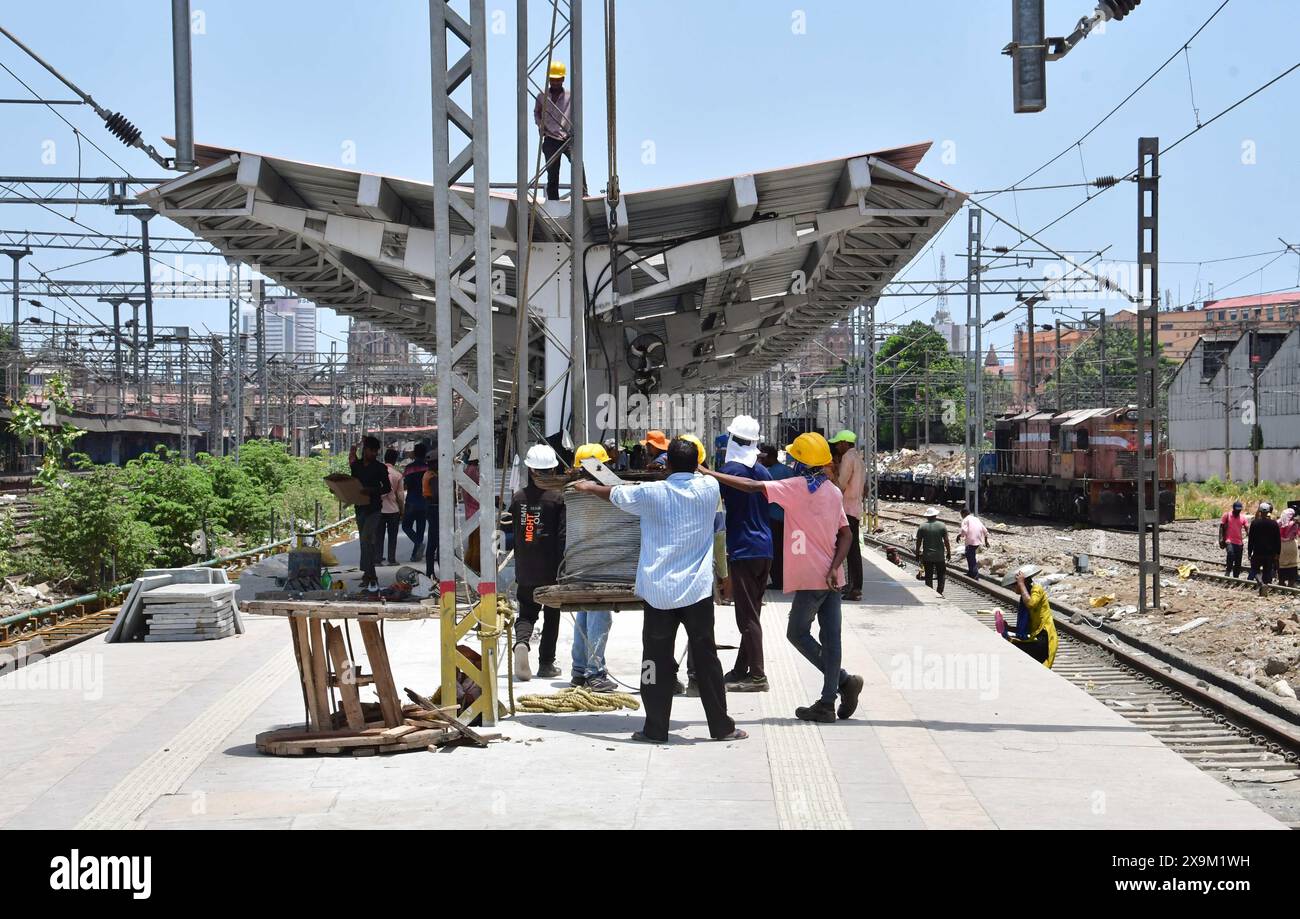MUMBAI, INDIA - JUNE 1: Laborers work for the extension of platforms 10 ...