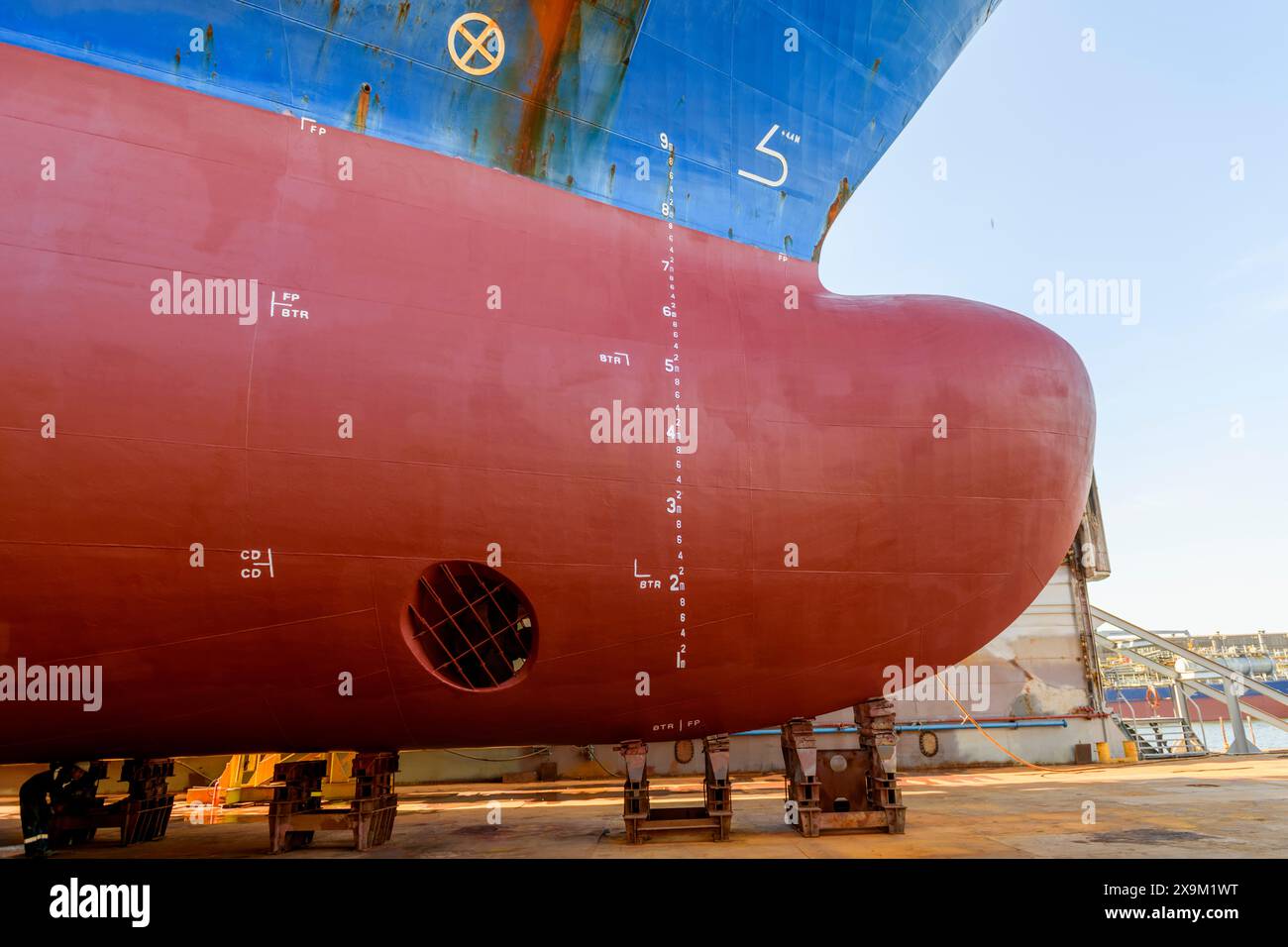 Cargo vessel in dry dock on ship repairing yard. Bow thruster Stock Photo - Alamy
