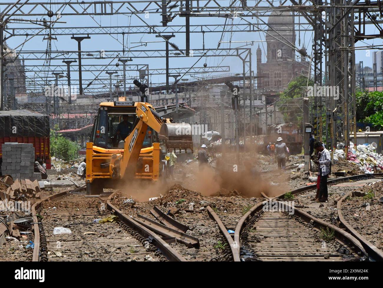 MUMBAI, INDIA - JUNE 1: Laborers work for the extension of platforms 10 ...
