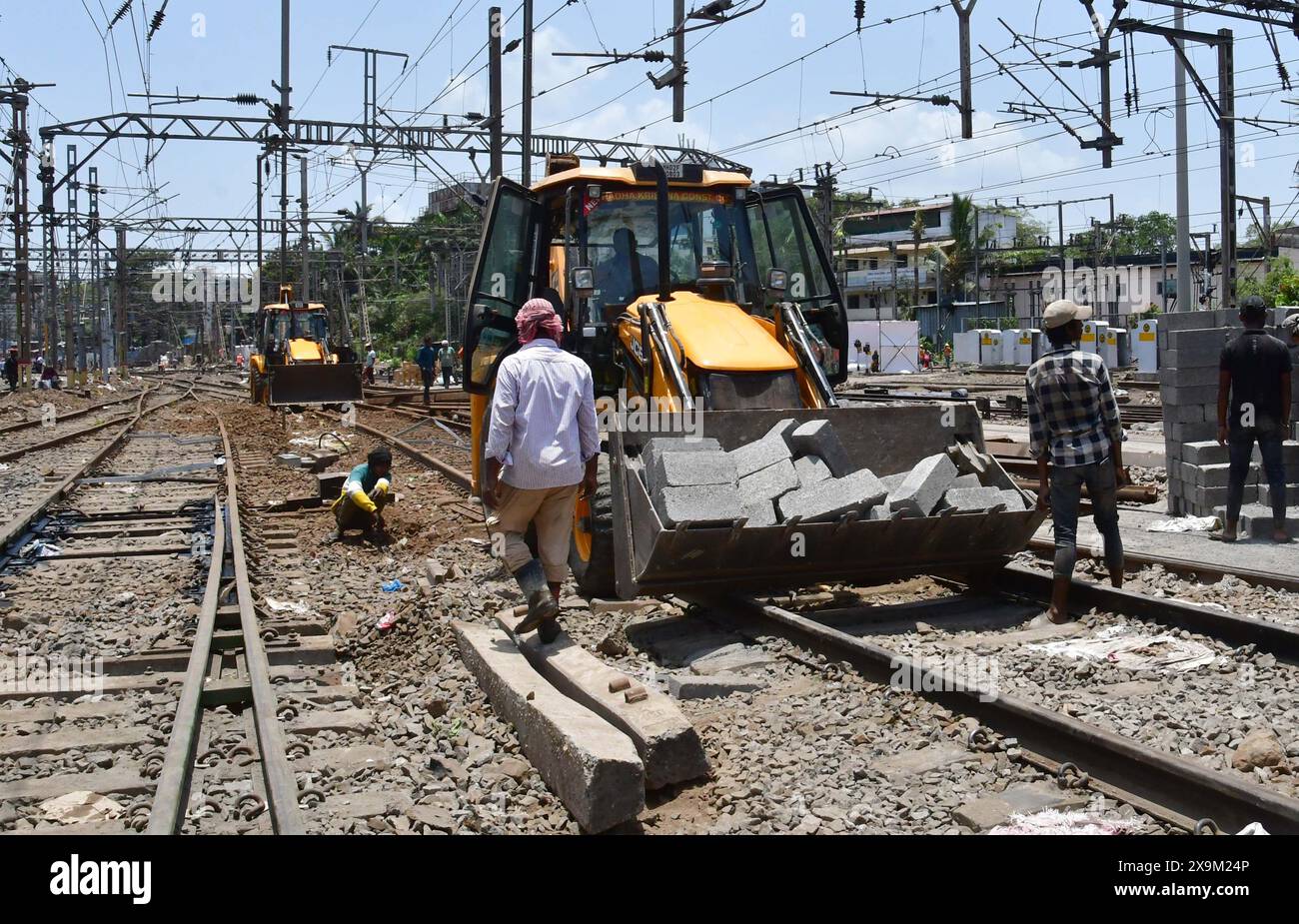 MUMBAI, INDIA - JUNE 1: Laborers work for the extension of platforms 10 ...