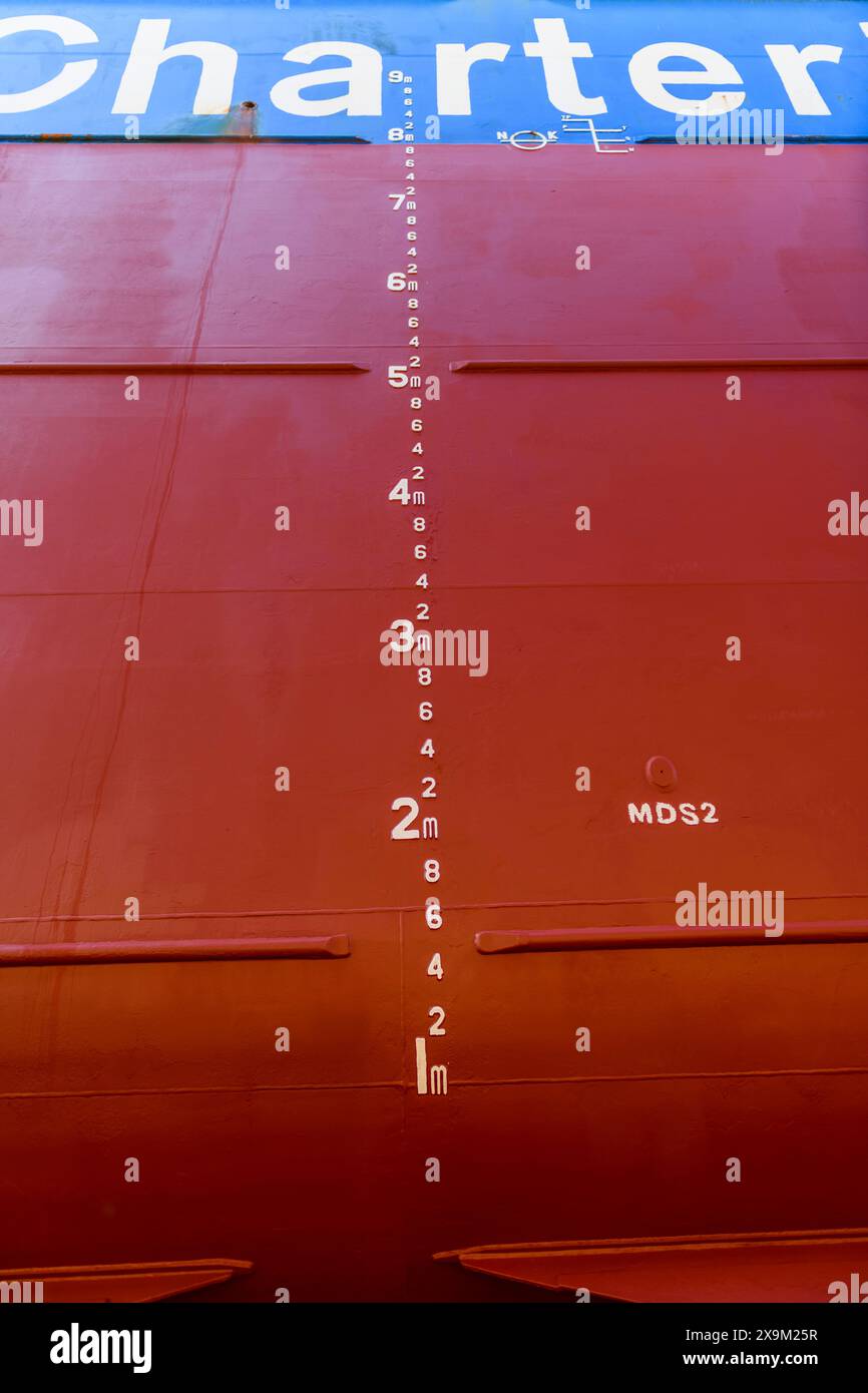 Cargo vessel in dry dock on ship repairing yard. Draught marks Stock ...
