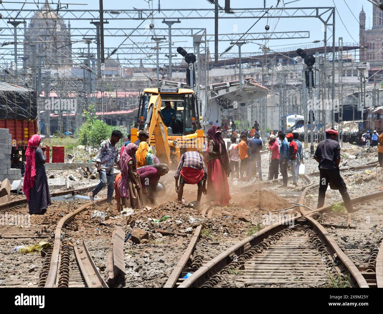 MUMBAI, INDIA - JUNE 1: Laborers work for the extension of platforms 10 ...