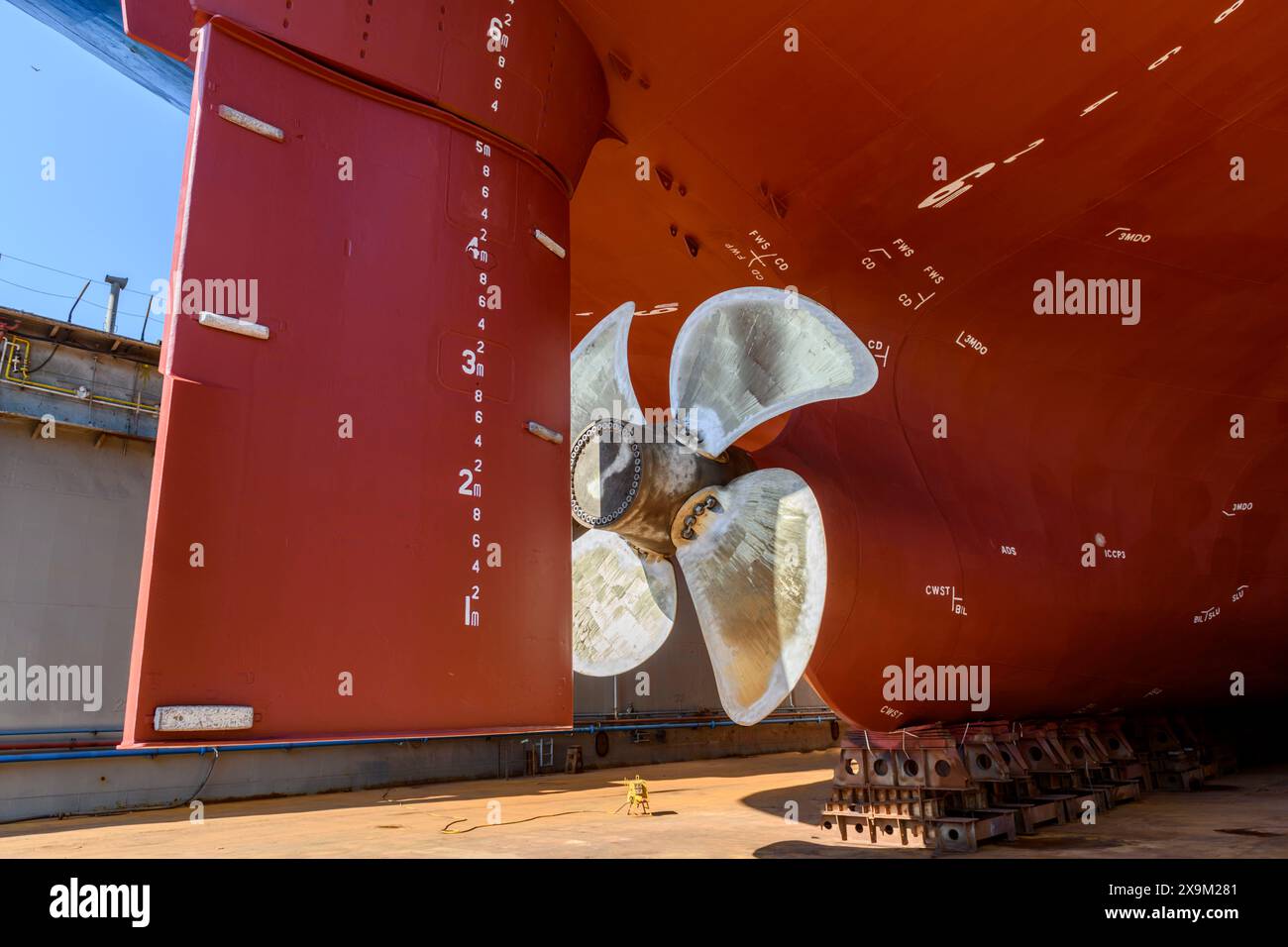 Cargo vessel in dry dock on ship repairing yard. Variable pitch ...