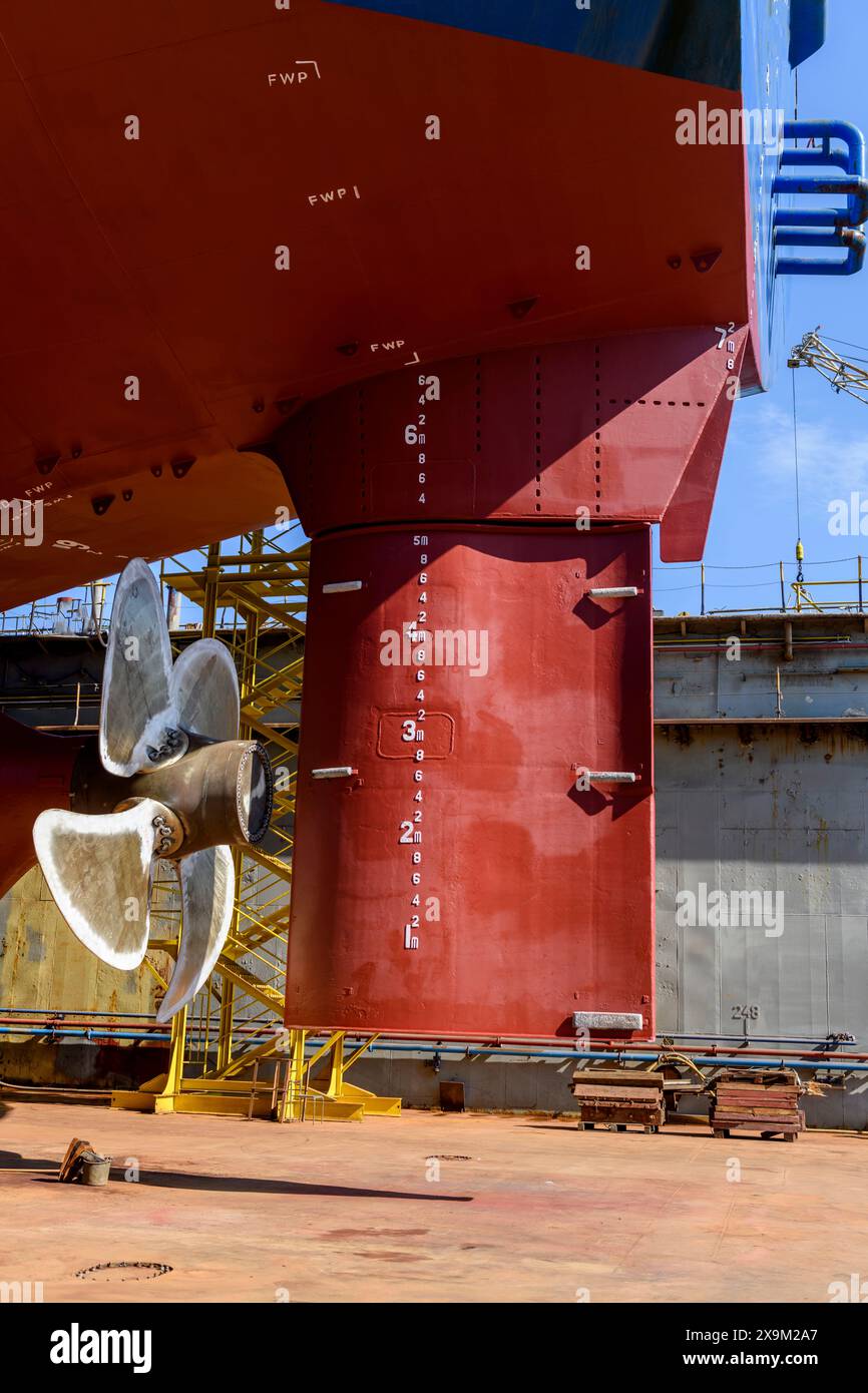 Cargo vessel in dry dock on ship repairing yard. Variable pitch ...