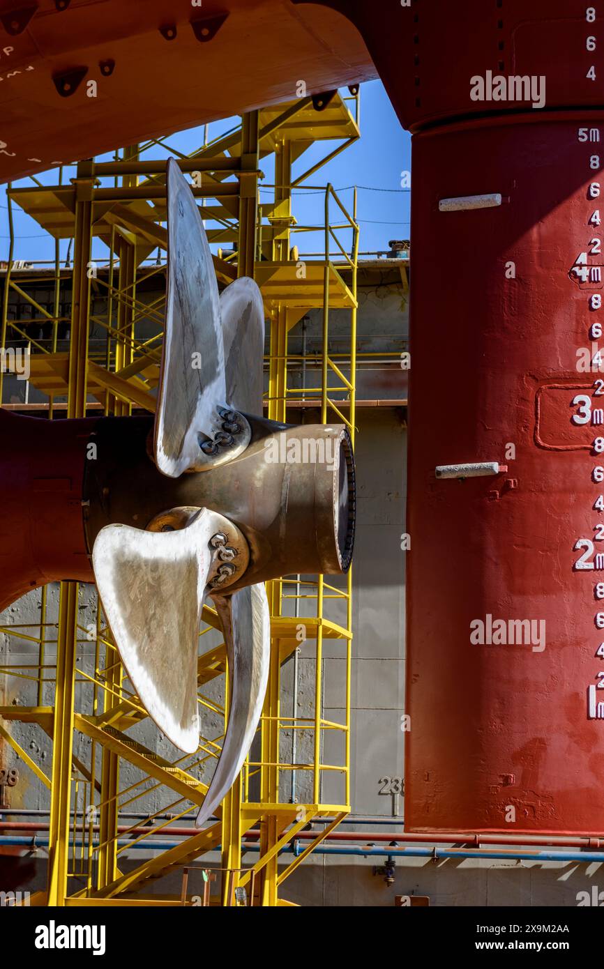 Cargo vessel in dry dock on ship repairing yard. Variable pitch ...