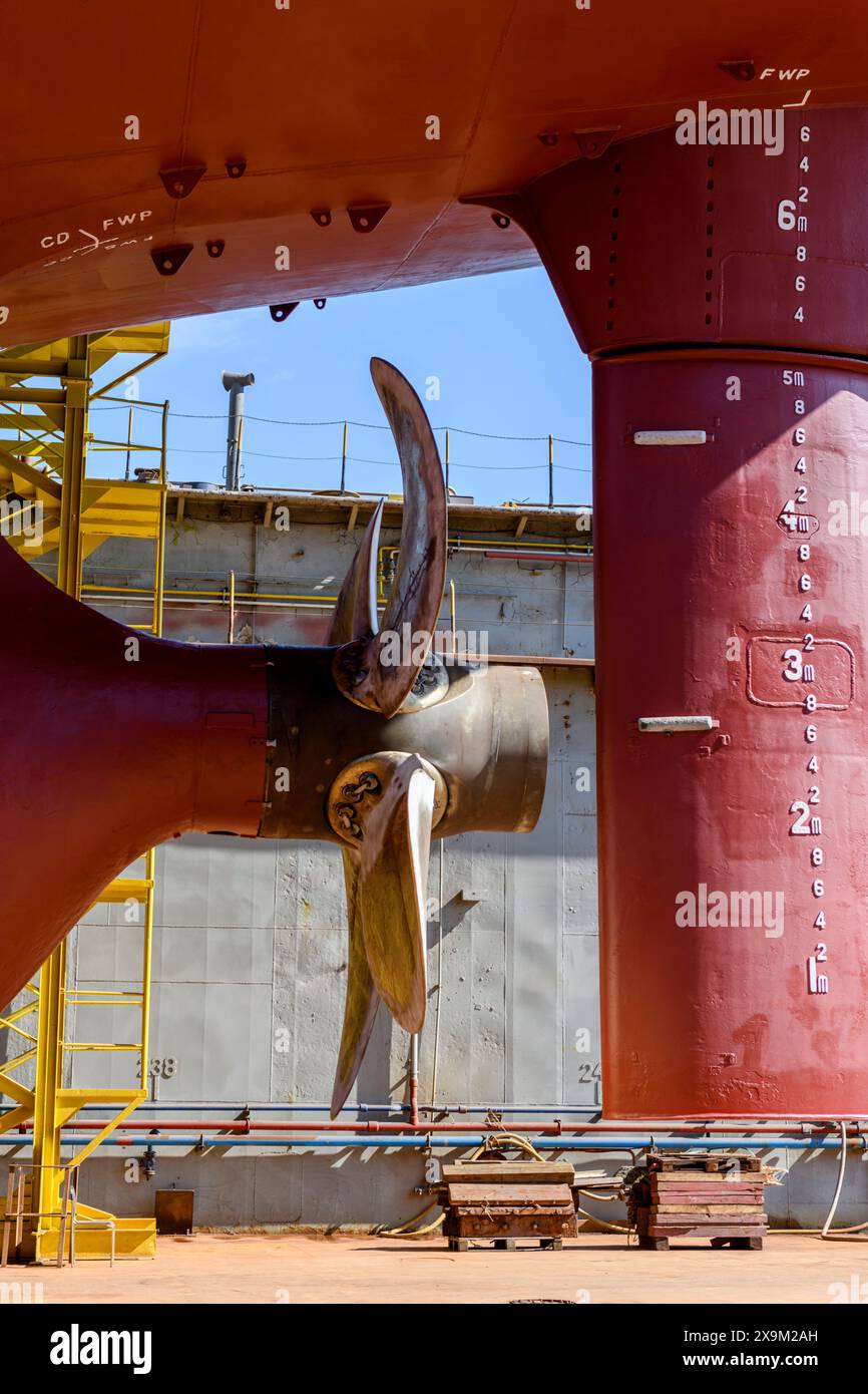 Cargo vessel in dry dock on ship repairing yard. Variable pitch ...