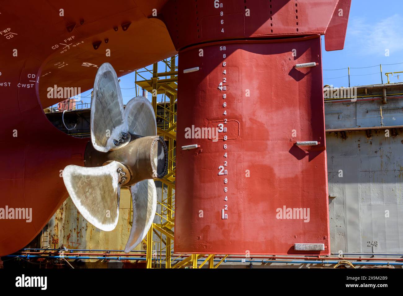 Cargo vessel in dry dock on ship repairing yard. Variable pitch ...