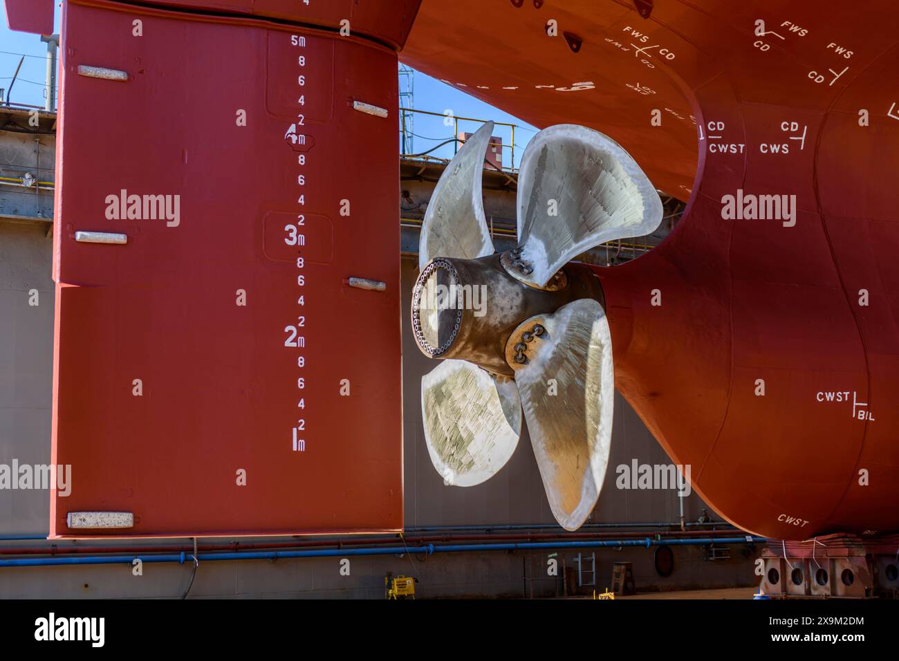 Cargo vessel in dry dock on ship repairing yard. Variable pitch ...