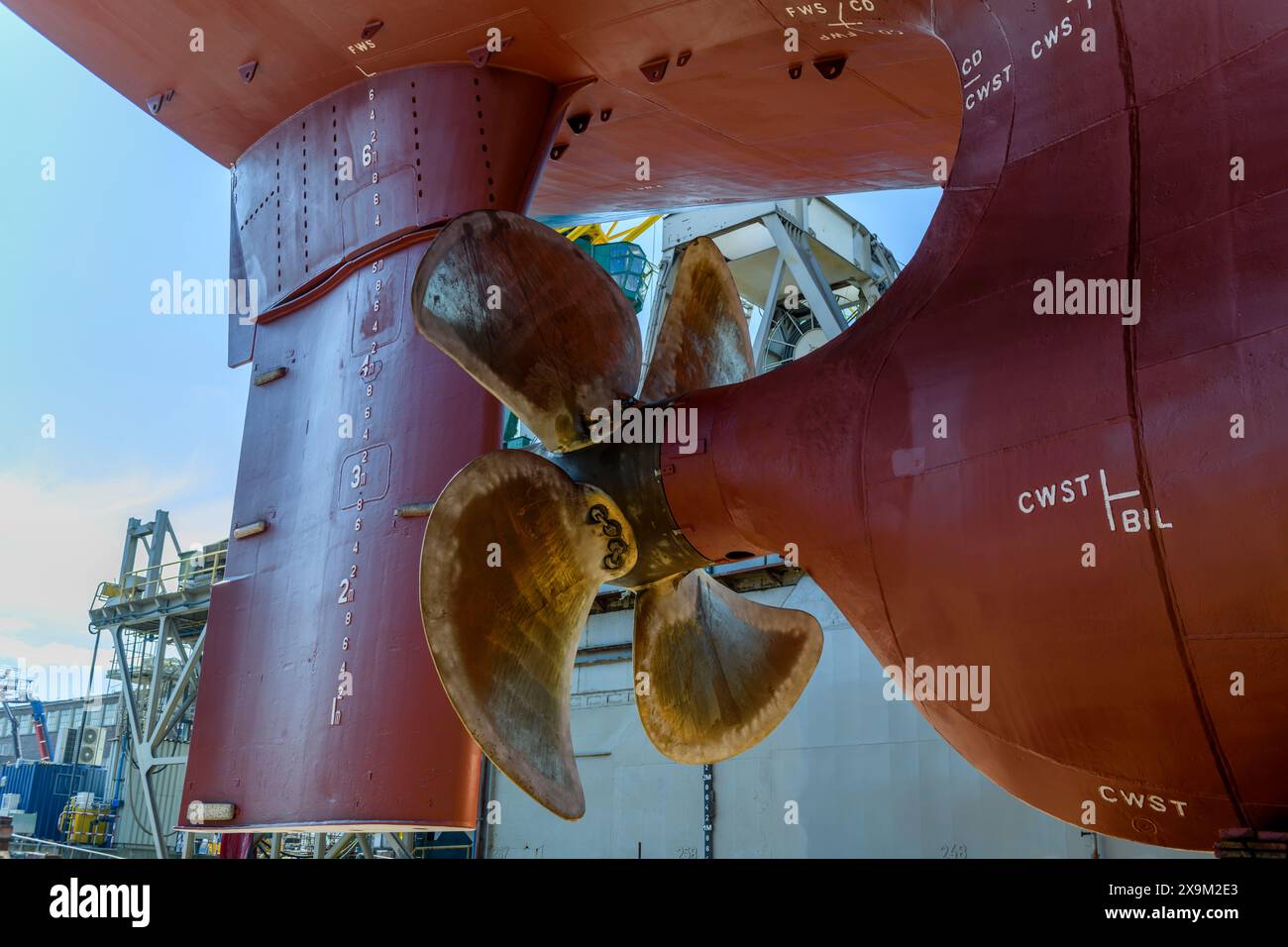 Cargo vessel in dry dock on ship repairing yard. Variable pitch ...
