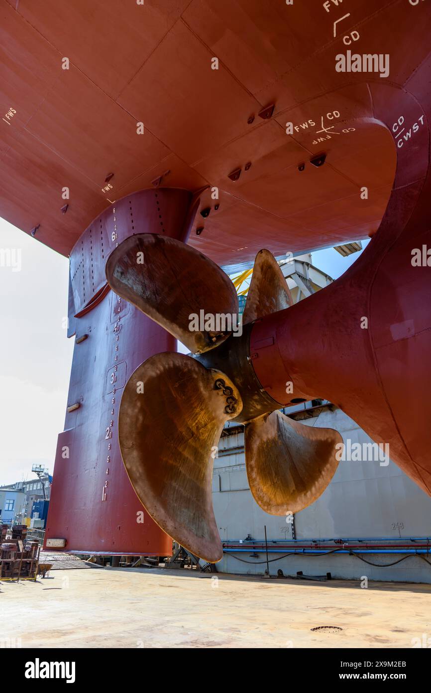 Cargo vessel in dry dock on ship repairing yard. Variable pitch ...