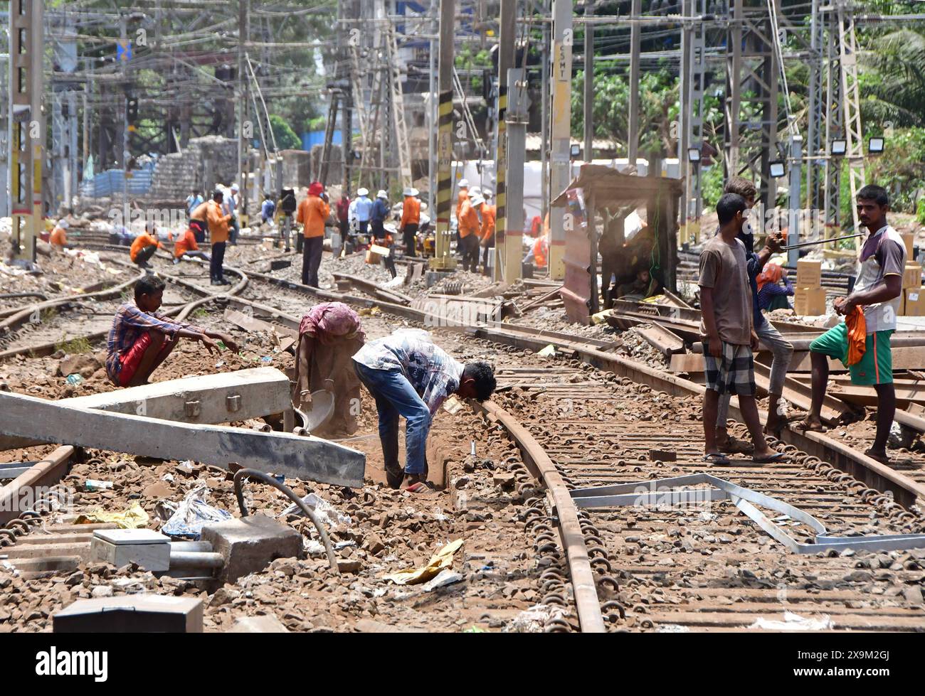 MUMBAI, INDIA - JUNE 1: Laborers work for the extension of platforms 10 ...
