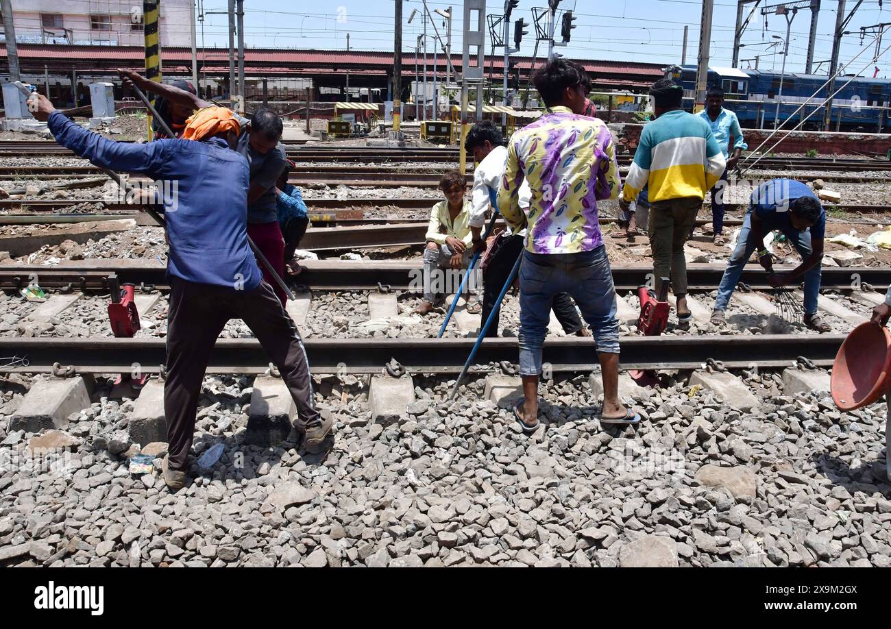 MUMBAI, INDIA - JUNE 1: Laborers work for the extension of platforms 10 ...