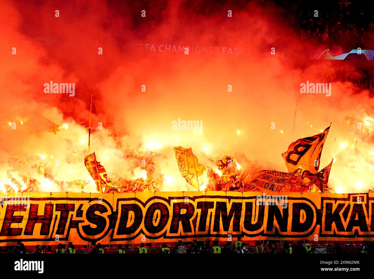 Borussia Dortmund fans let off smoke flares in the stands during the ...