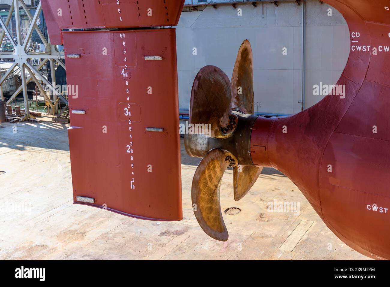 Cargo vessel in dry dock on ship repairing yard. Variable pitch ...