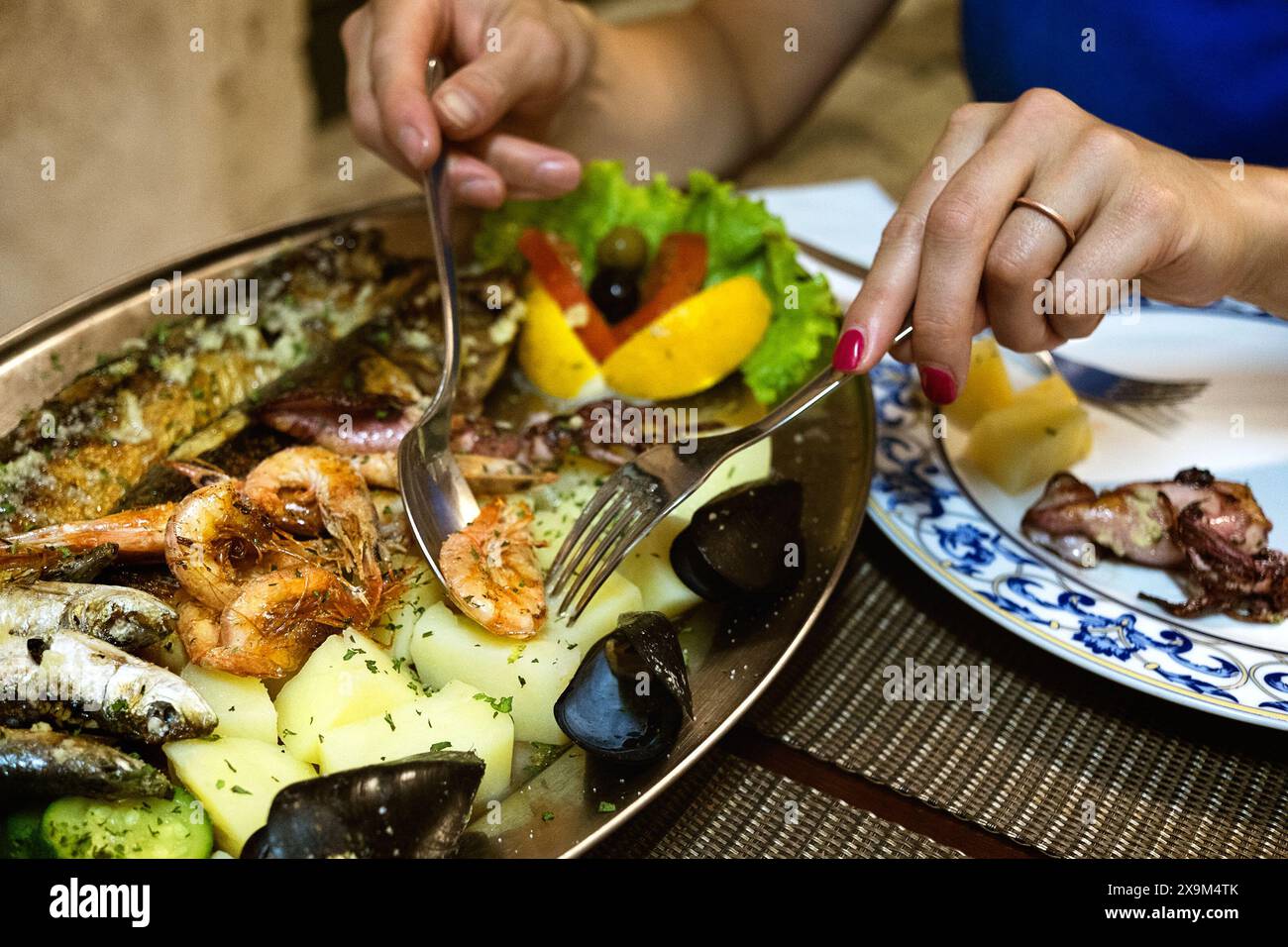 Woman Eating Fish in Restaurant Stock Photo - Alamy