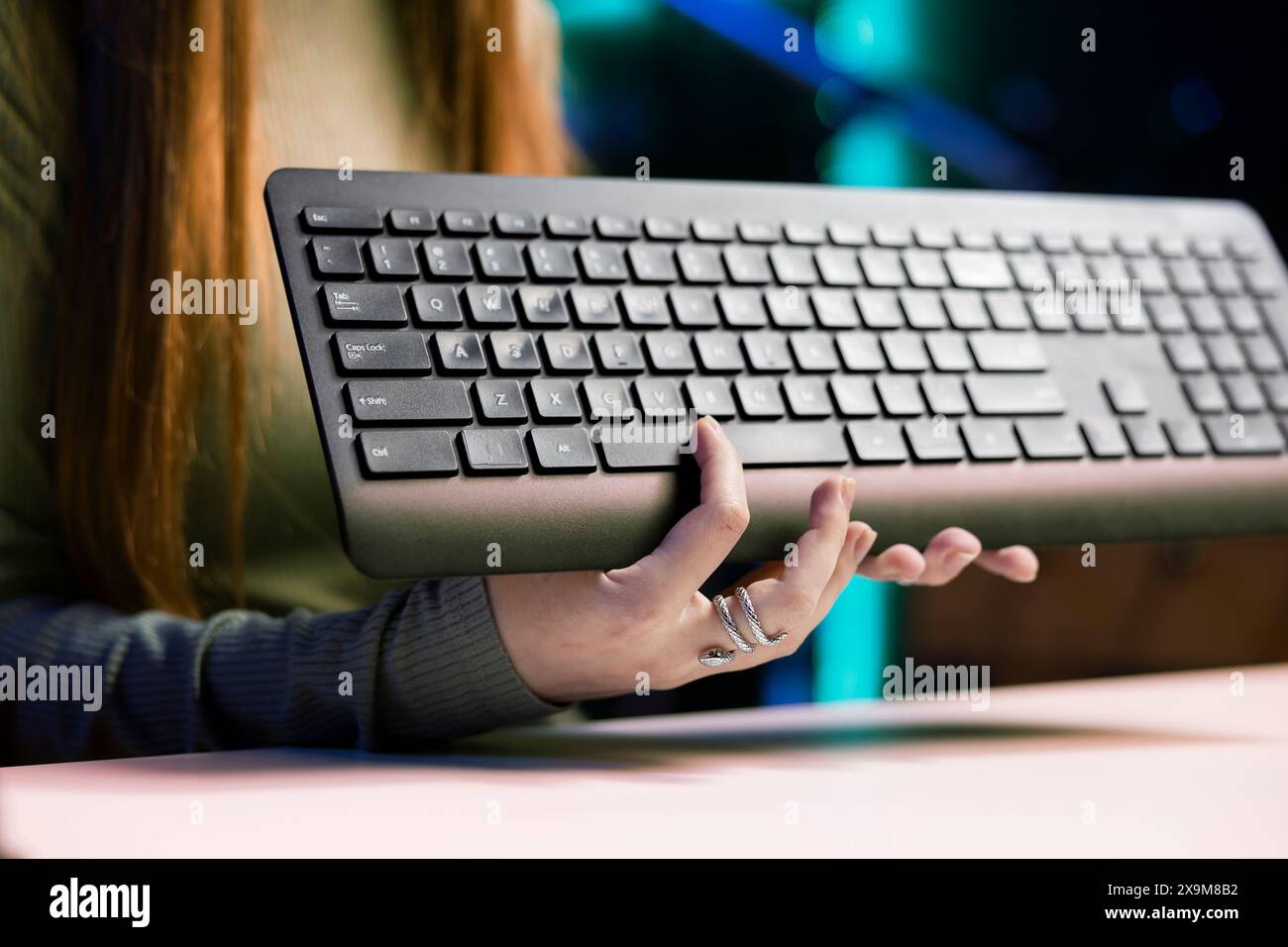 Gen Z girl typing on mechanical keyboard while doing review in personal ...