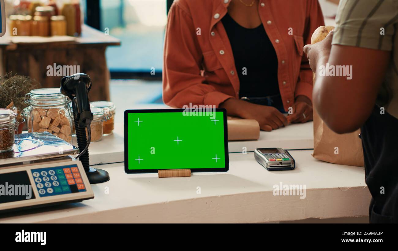 Tablet running display with blank greenscreen at checkout, showing ...